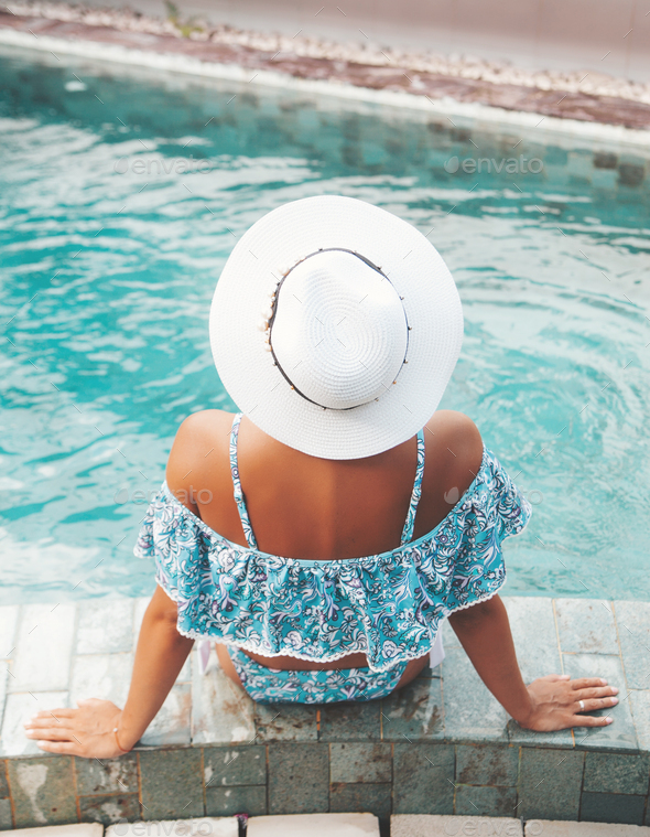 Back view of hot woman posing near swimming pool Stock Photo by halayalex