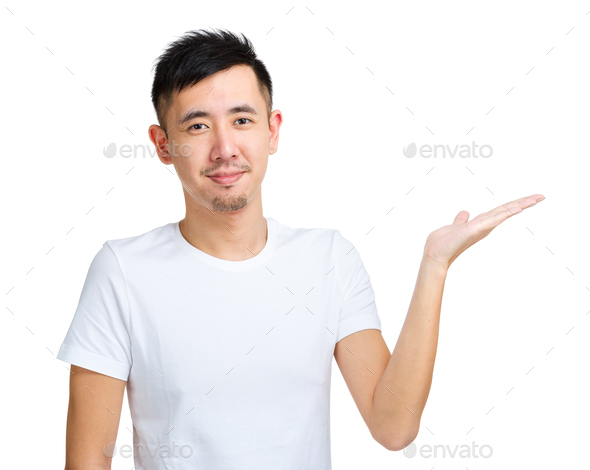 Young man with hand showing something Stock Photo by leungchopan ...