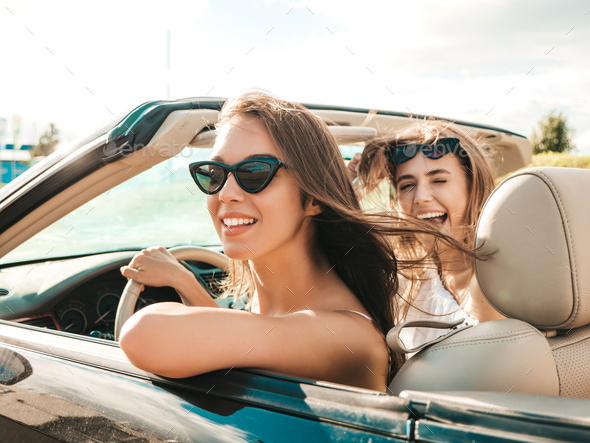 Portrait of two young funny girls driving cabriolet car Stock Photo by ...