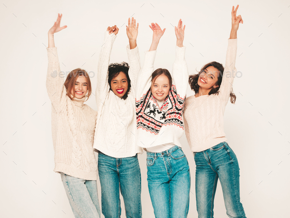 Portrait of four beautiful women posing in studio Stock Photo by halayalex