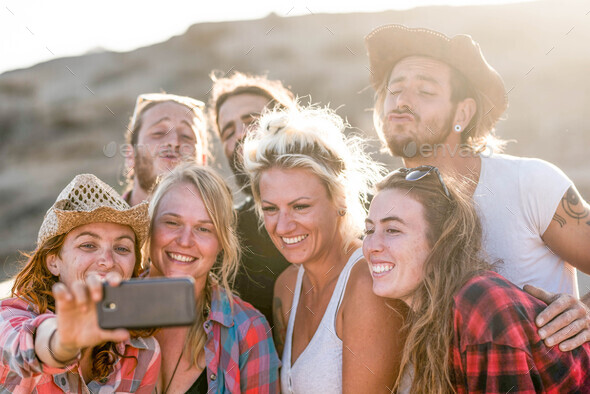 group of seven people having fun together looking at the camera and ...