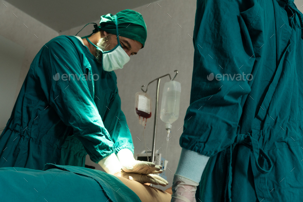 surgeon giving cpr to patient in operating room Stock Photo by ...