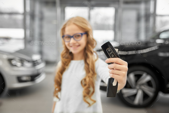 Car keys close up, child holding keys, posing Stock Photo by serhiibobyk