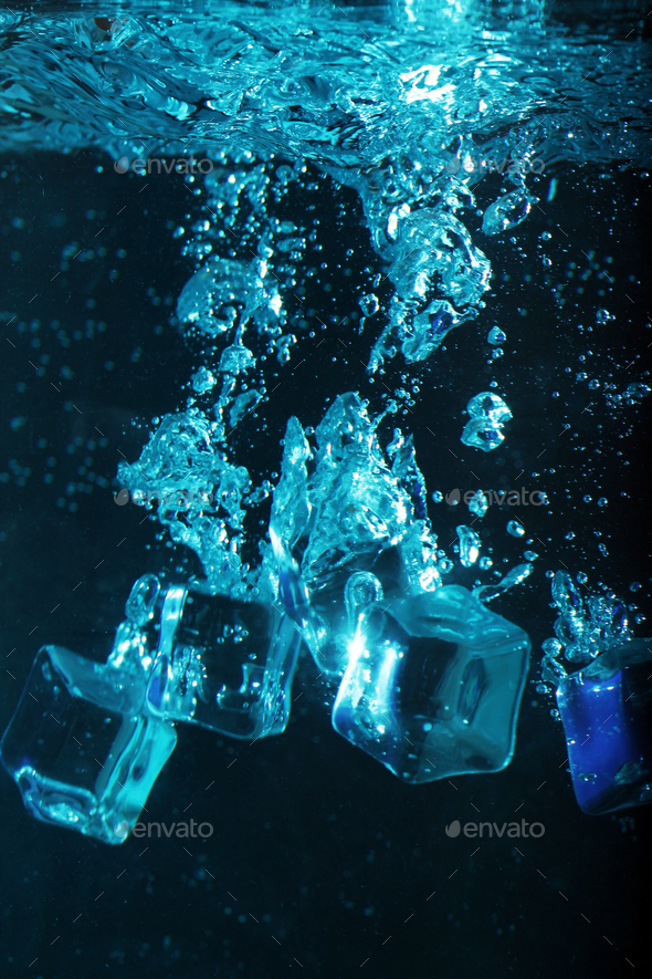Ice cubes with bubbles underwater Stock Photo by Microstock_Growth