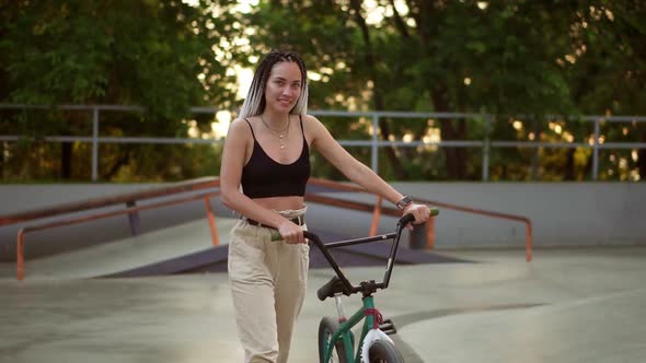 Attractive Stylish Girl with Dreadlocks Walks with Bmx Bike in ...