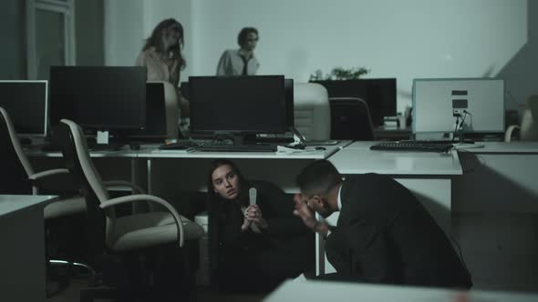 Businesspeople Hiding behind Desks during Zombie Apocalypse, Stock Footage