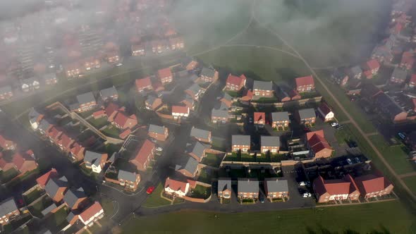 Aerial view of a residential estate covered by fog and clouds, Stock ...