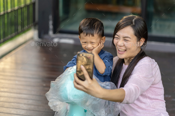 Asian single mom with son are selfie together when living in loft house ...
