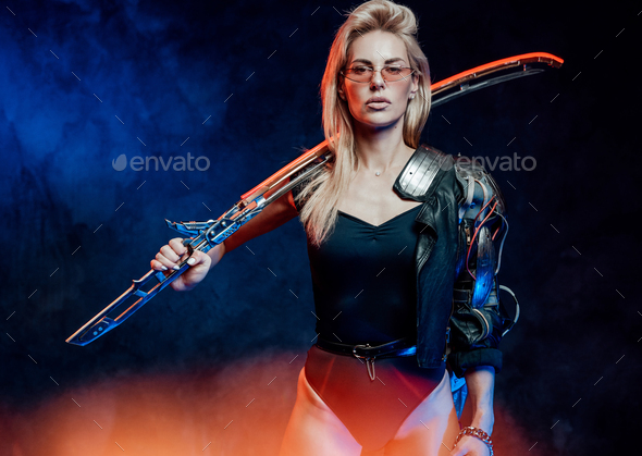 Beautiful female model in cyberpunk style with sword in studio Stock ...