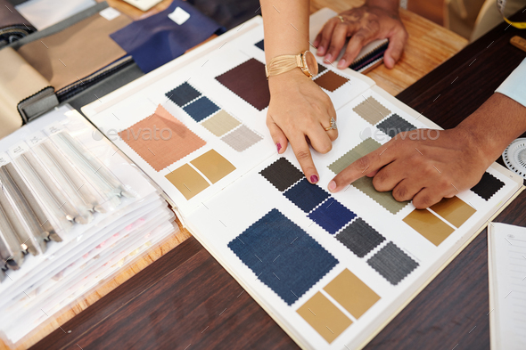 Choosing fabric from catalog Stock Photo by DragonImages | PhotoDune