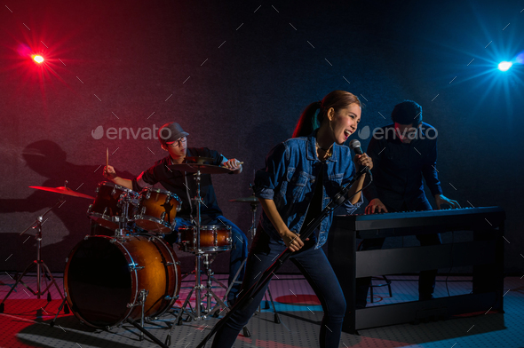 Musician band hand holding the microphone and singing a song and ...