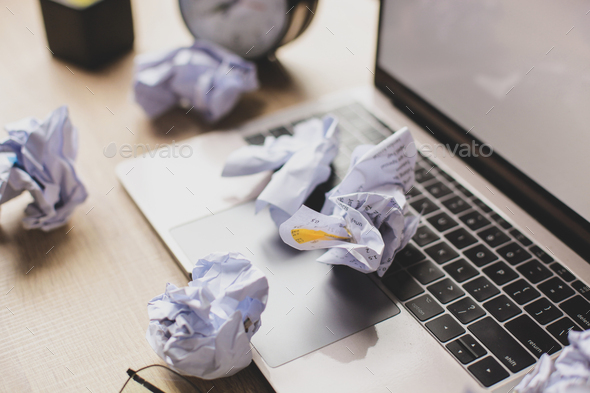 Crumpled Paper and Laptop on Office Desk Stock Photo by Garakta-Studio