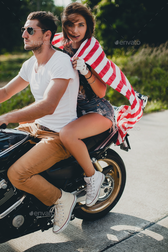 young couple in love, riding a motorcycle, hug, passion, free spirit ...