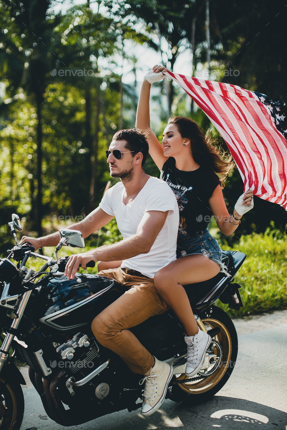 young couple in love, riding a motorcycle, hug, passion, free spirit ...