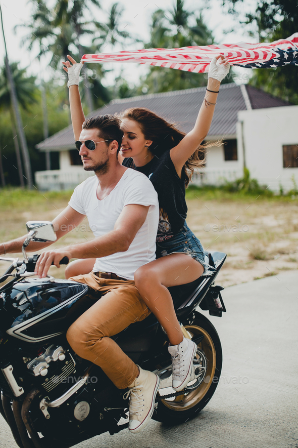 young couple in love, riding a motorcycle, hug, passion, free spirit ...