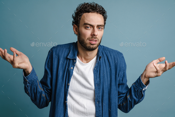 Confused handsome guy posing with hands-up at camera Stock Photo by ...