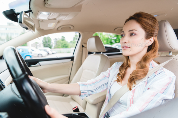 side view of pensive attractive woman driving car Stock Photo by ...