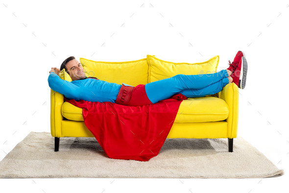 superman lying on couch and smiling at camera isolated on white Stock ...