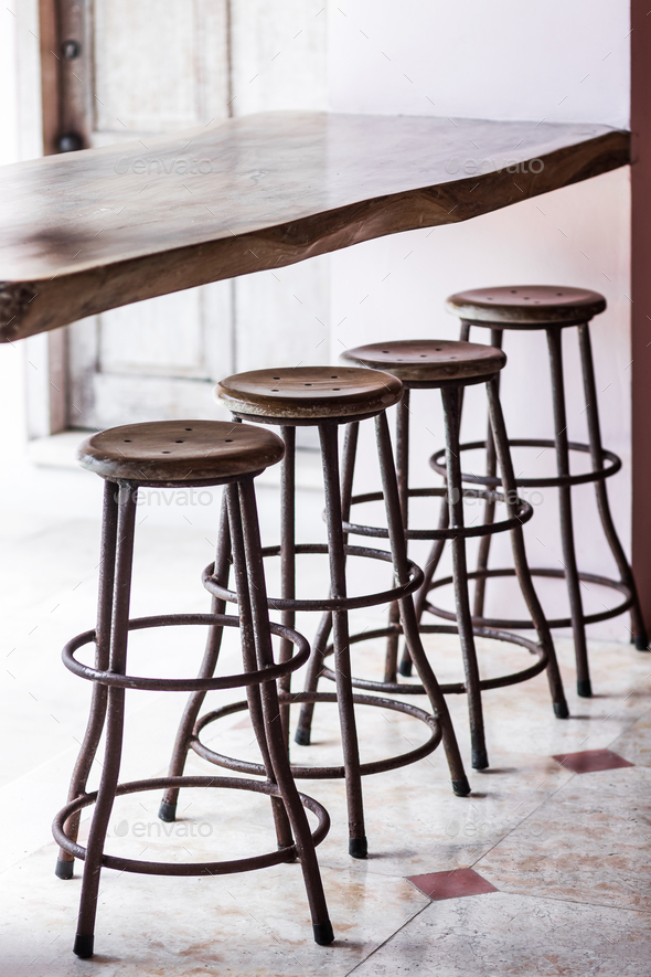 Bar with wooden vintage round tall chairs Stock Photo by olegbreslavtsev
