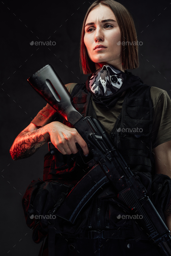 Armed with rifle attractive woman in dark background Stock Photo by ...