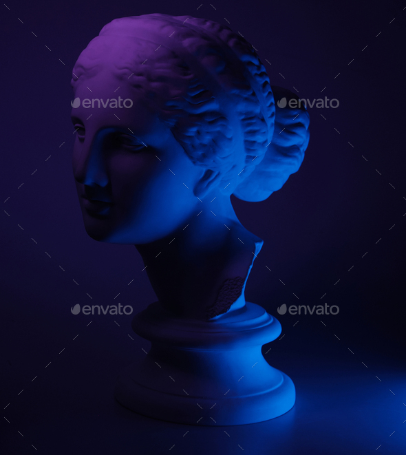 Dark portrait of a single female bust with in shadows and cold colors ...