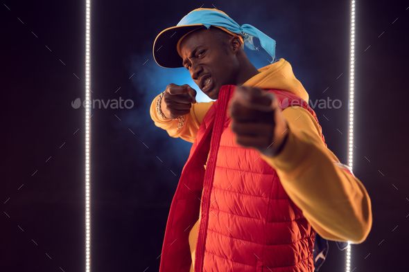 Rapper poses in studio with linear illumination Stock Photo by NomadSoul1