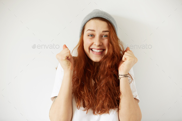 Headshot of young happy female wearing gray cap and T-shirt with joyful ...