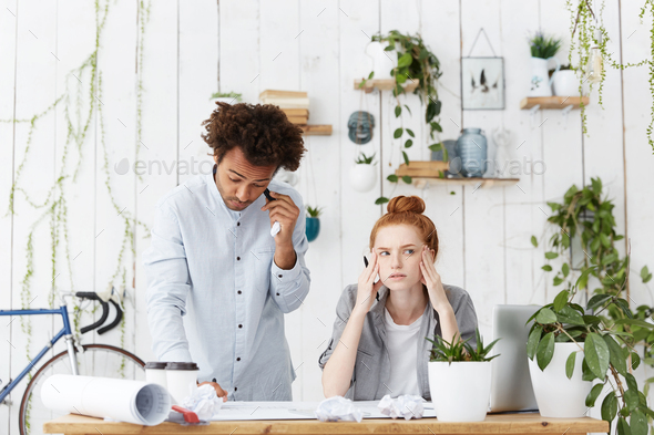 Teamwork, cooperation and brainstorming. Frustrated Caucasian woman ...