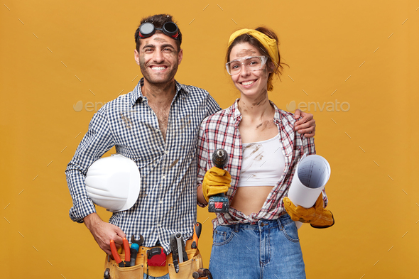 Studio portrait of happy positive maintenance employees working ...