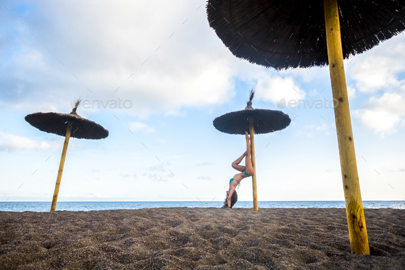 Yoga balance reverse position at the beach for healthy leisure activity ...
