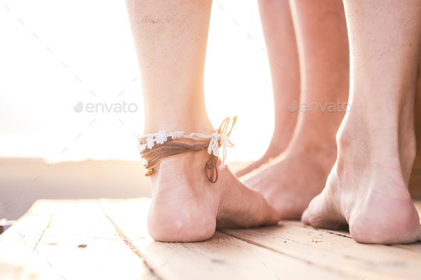Close up of two pair of feet standing together in love and relationship ...