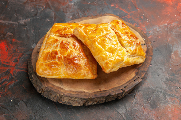 bottom view penovani khachapuri on wood board on dark red background ...