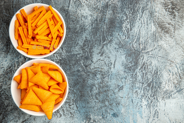 top view different snacks rusks and cheese cips on light floor cinema ...