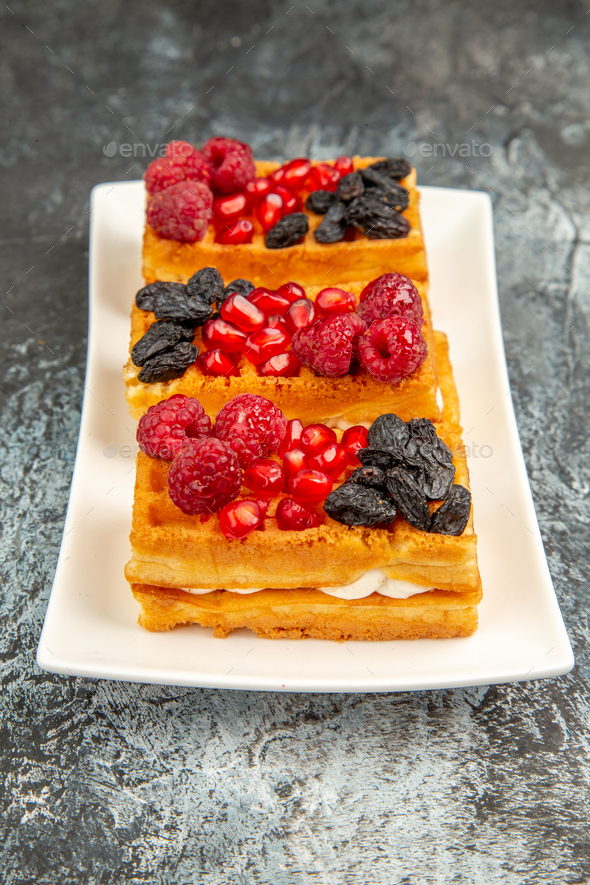 bottom view berry waffles on white rectangular plate on grey-white ...