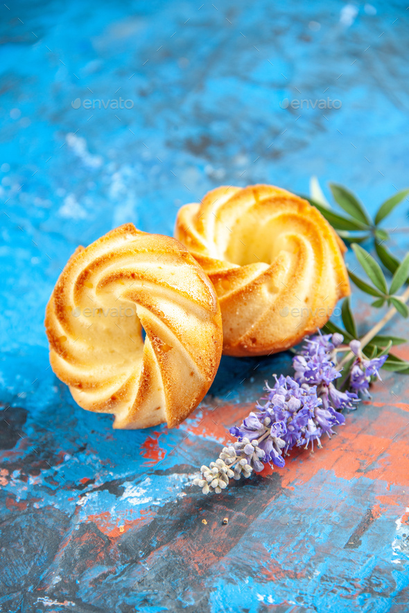 front view biscuits purple flowers on blue table free place Stock Photo ...