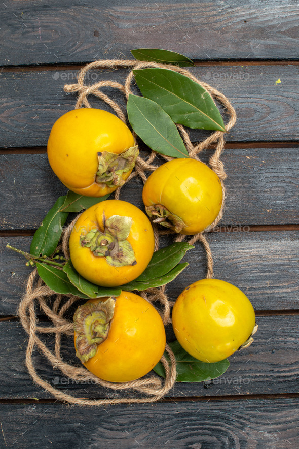 top view fresh sweet persimmons on a wooden rustic desk ripe fruit tree ...