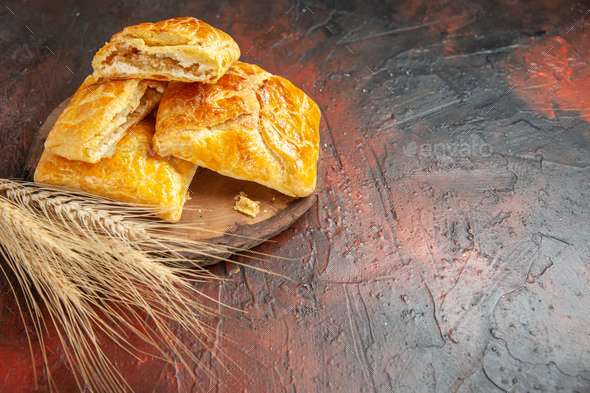 bottom view penovani khachapuri on wood board wheat spike on dark red ...