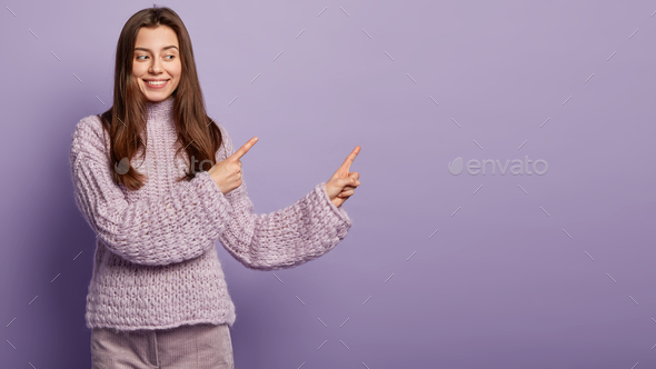 Charming pleasant looking lady with pleased facial expression, looks ...