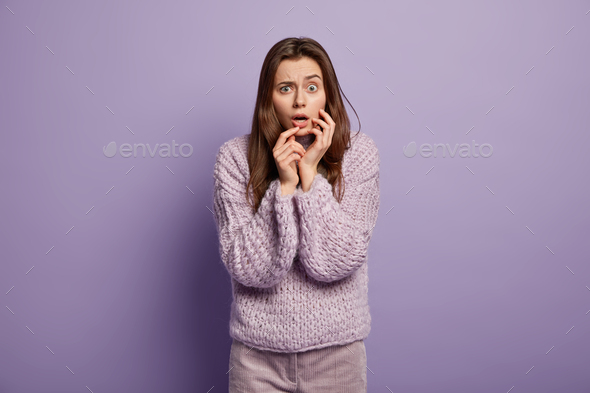 Panicking astonished worried young woman gasps perplexed, raises ...