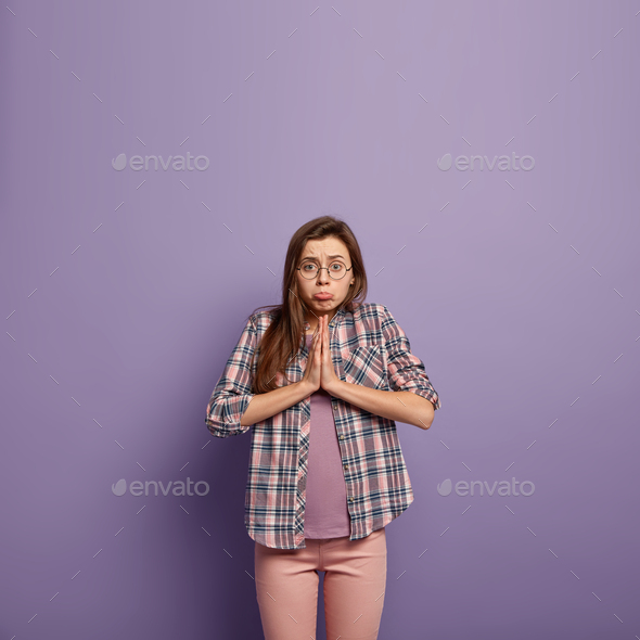 Miserable woman purses lower lips, pleads for mercy, has pity facial ...