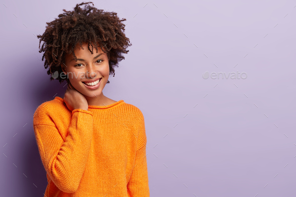 Indoor shot of lovely optimistic woman has friendly expression, sensual ...
