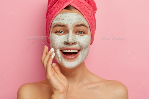 Close up portrait of happy overjoyed female model with cosmetic facial ...