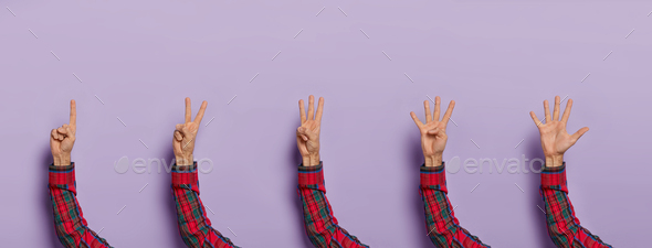 Male hands counting from one to five. Man shows fingers against purple ...