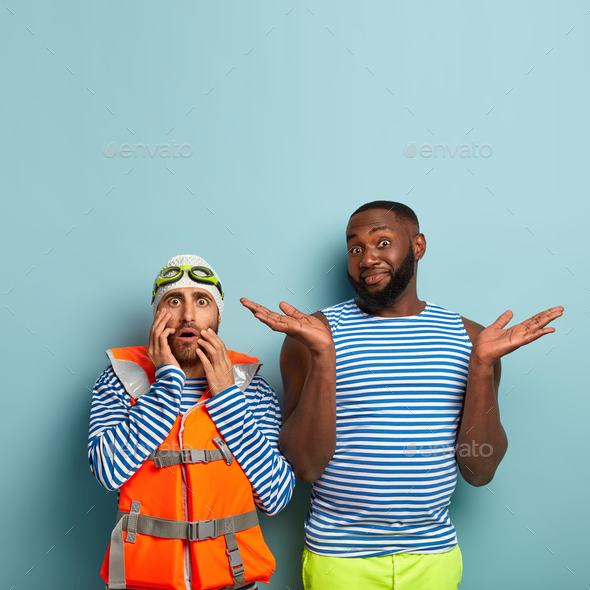 Scared European male swimmer afraids of something, wears swimhat ...