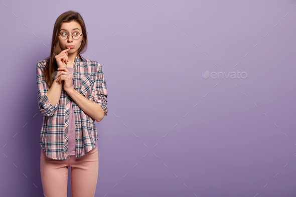 Sad depressed female purses lips, looks aside, has thoughtful dejected ...