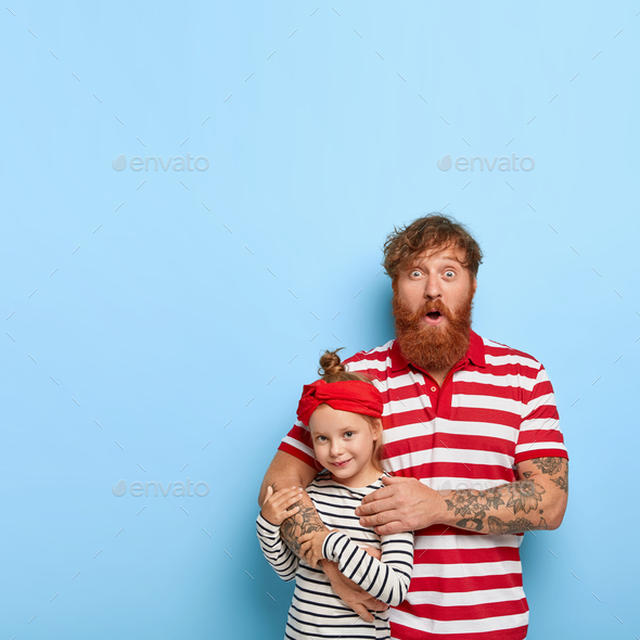 Shocked bearded redhead father in striped t shirt and his preschool ...
