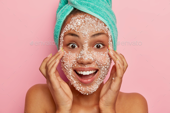 Horizontal shot of happy surprised woman wants to refresh face skin ...