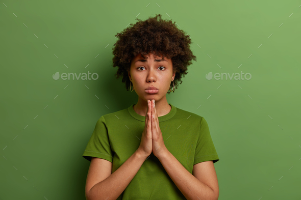 Photo of dark skinned woman looks with imploring beseeching grimace ...