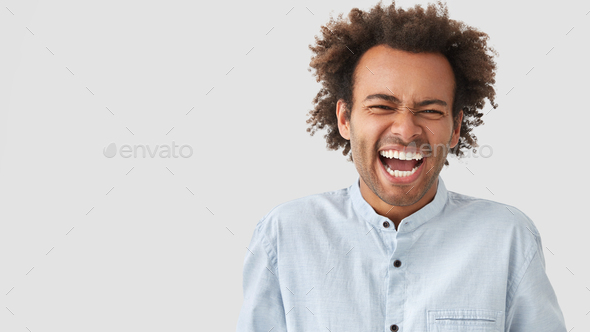 Comic mixed race young male has fun with friends, tell each other ...