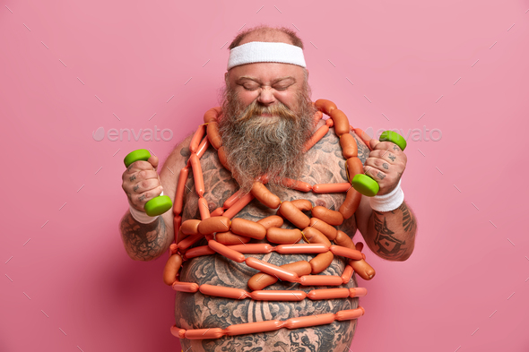 Diet, sport and willpower. Happy motivated guy with fat belly, fights ...